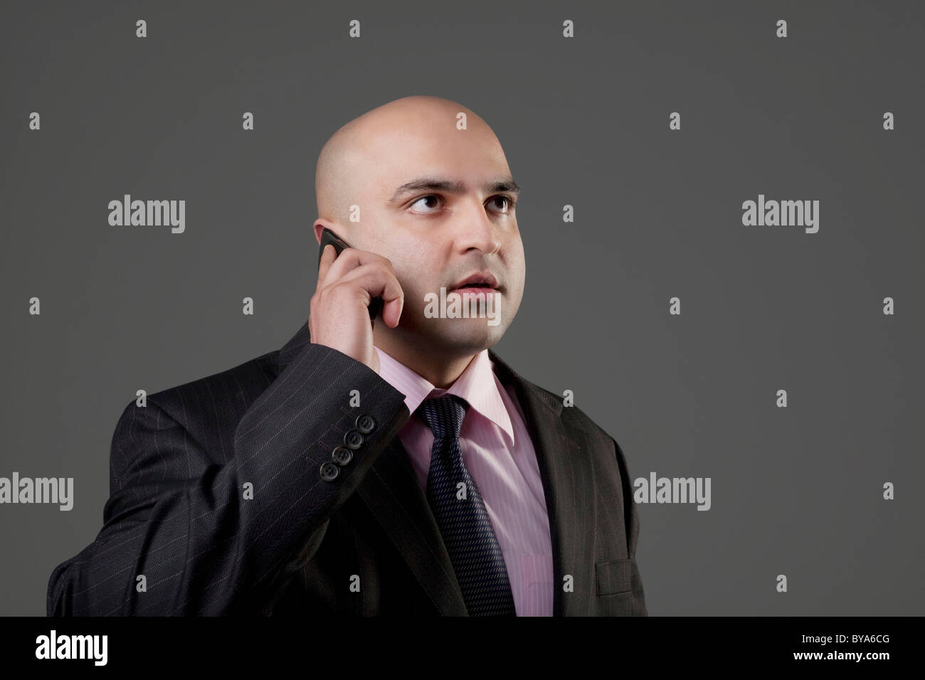 Bald businessman talking on the mobile phone Stock Photo - Alamy