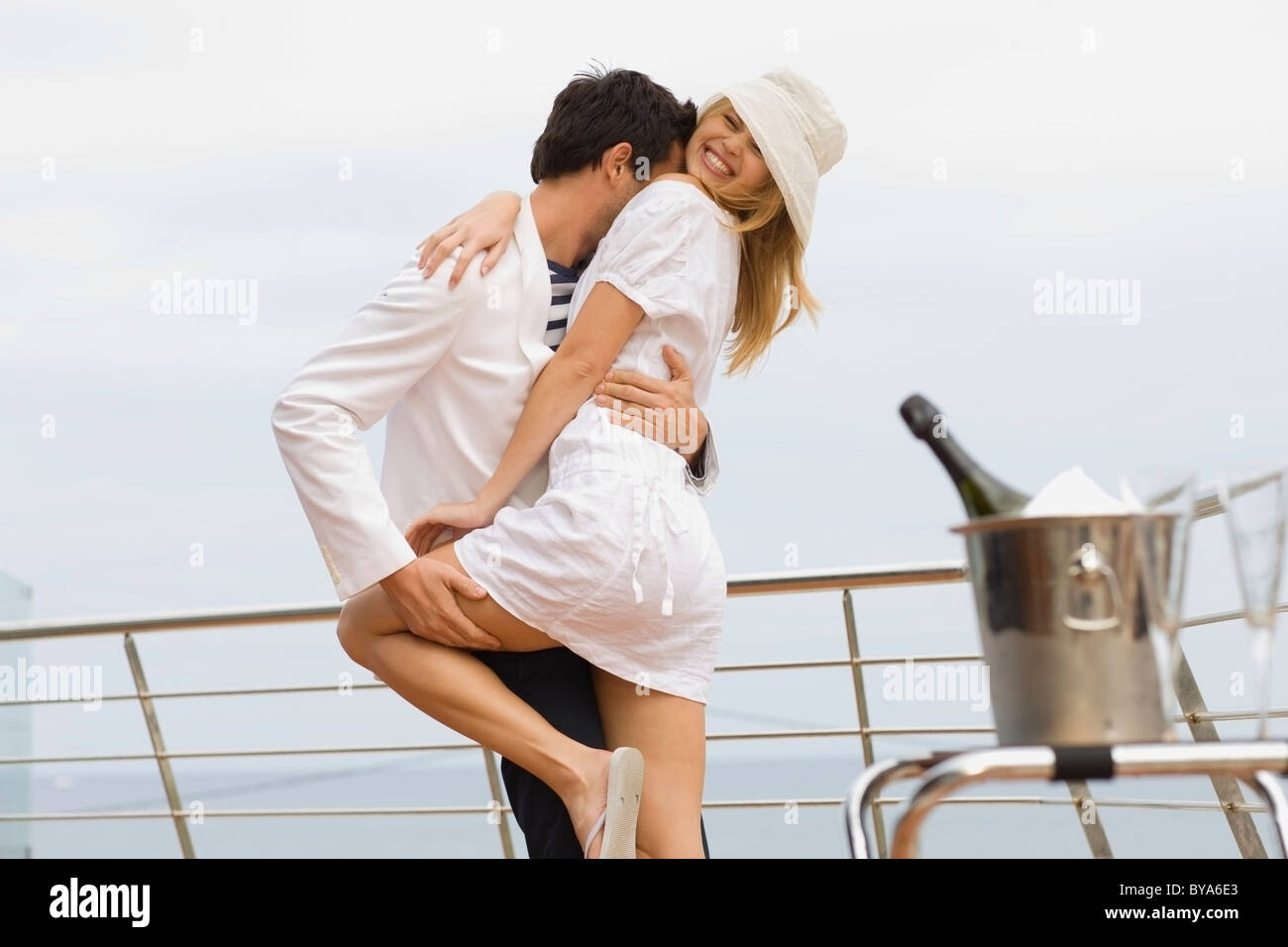 Couple standing at railing Stock Photo - Alamy