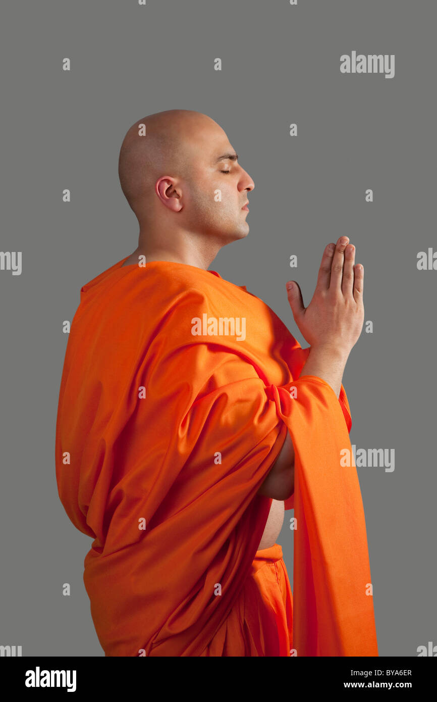 A monk praying Stock Photo - Alamy