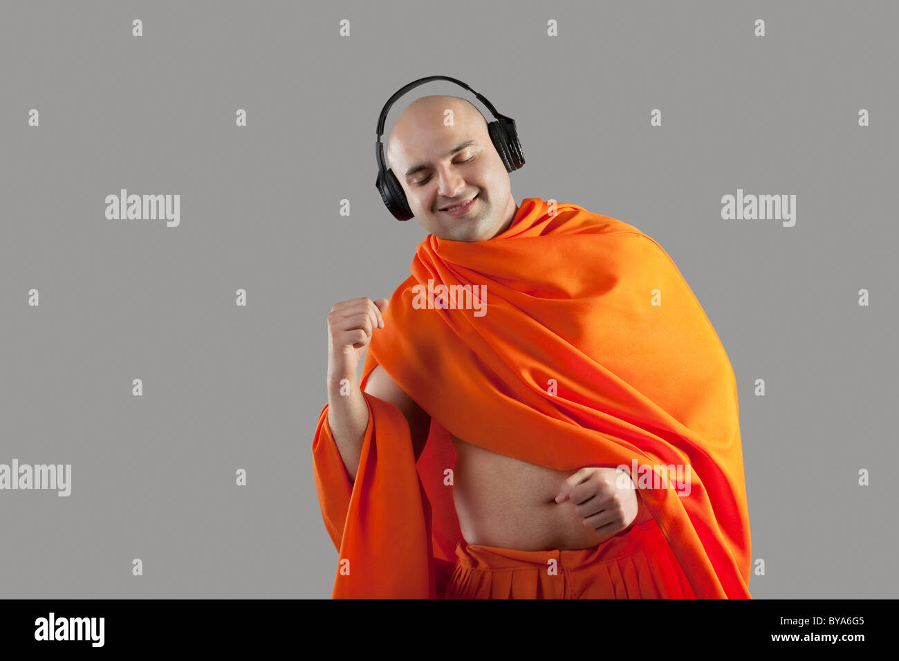 Monk listening to music Stock Photo - Alamy