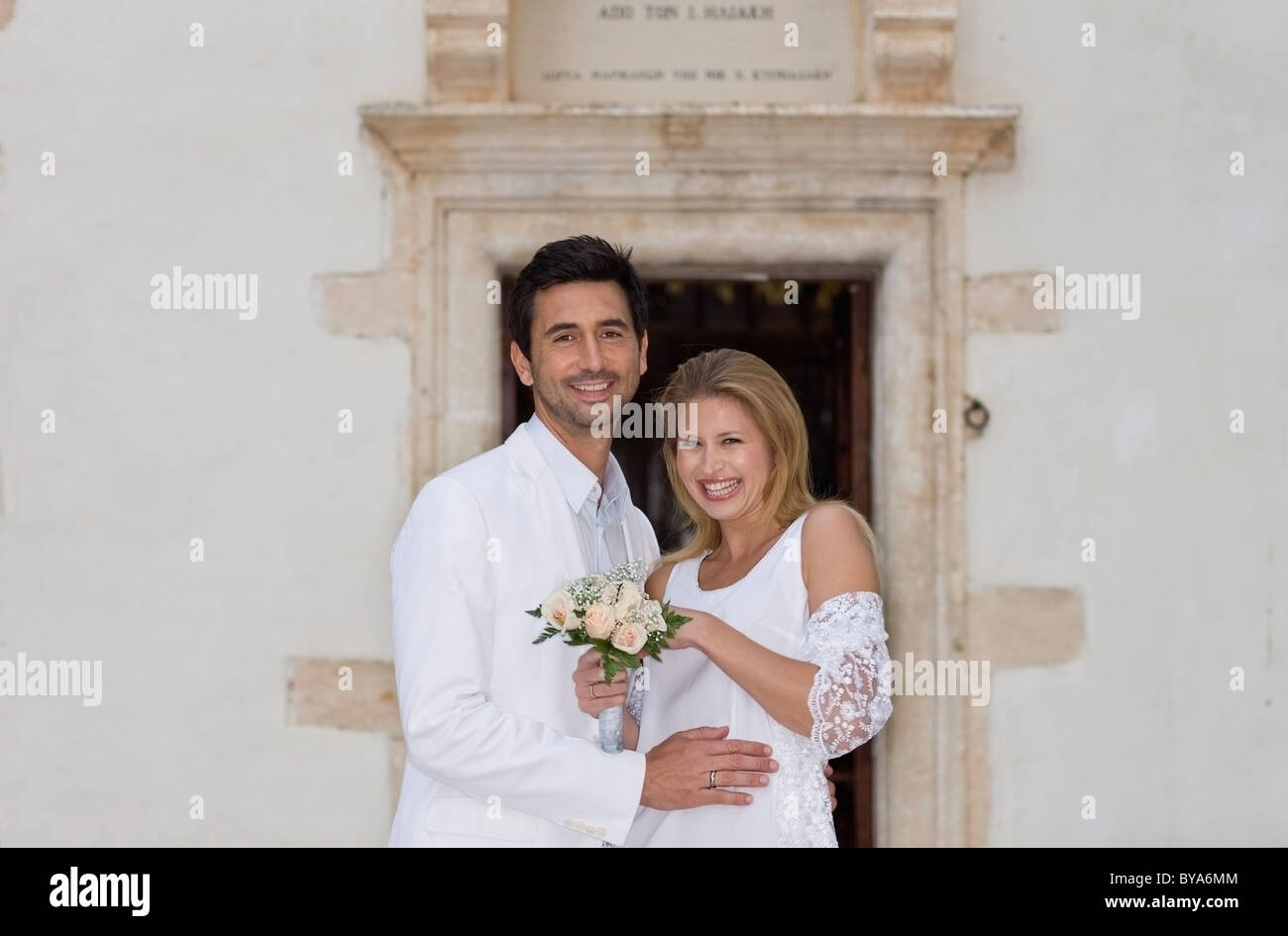 Bridal couple in front of church Stock Photo - Alamy