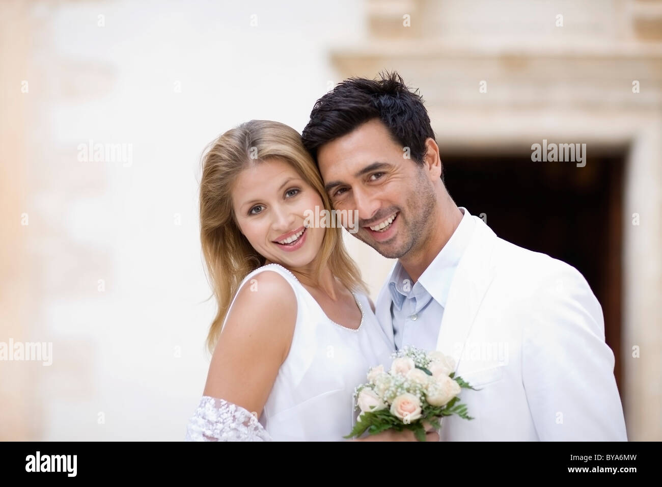 Bridal couple in front of church Stock Photo - Alamy