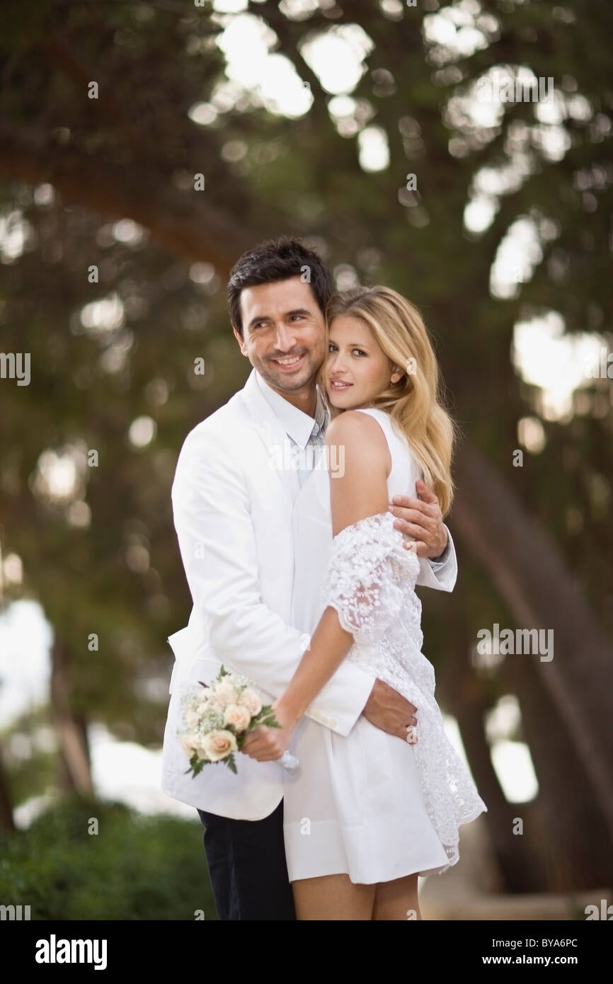 Hugging bridal couple Stock Photo - Alamy