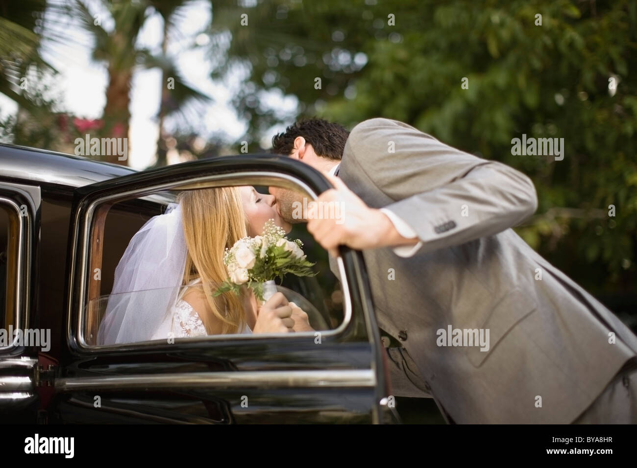 Kissing bridal couple Stock Photo - Alamy