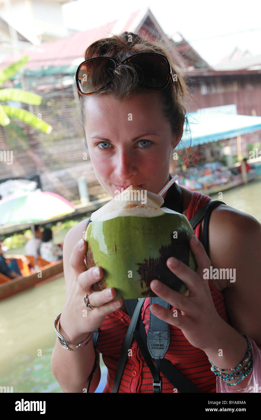 Female drinking coconut milk from a coconut Stock Photo - Alamy