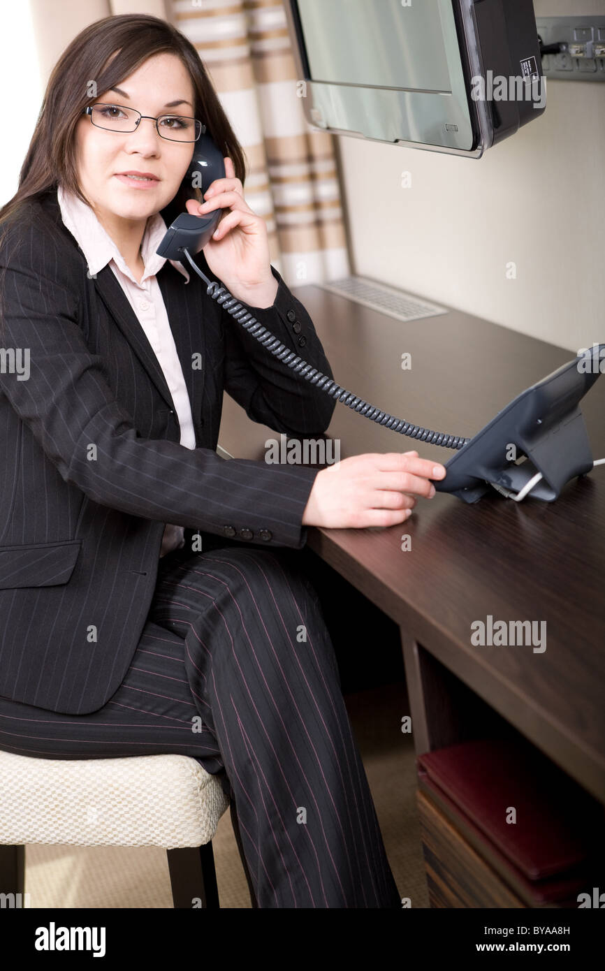 young adult woman at reception desk Stock Photo - Alamy