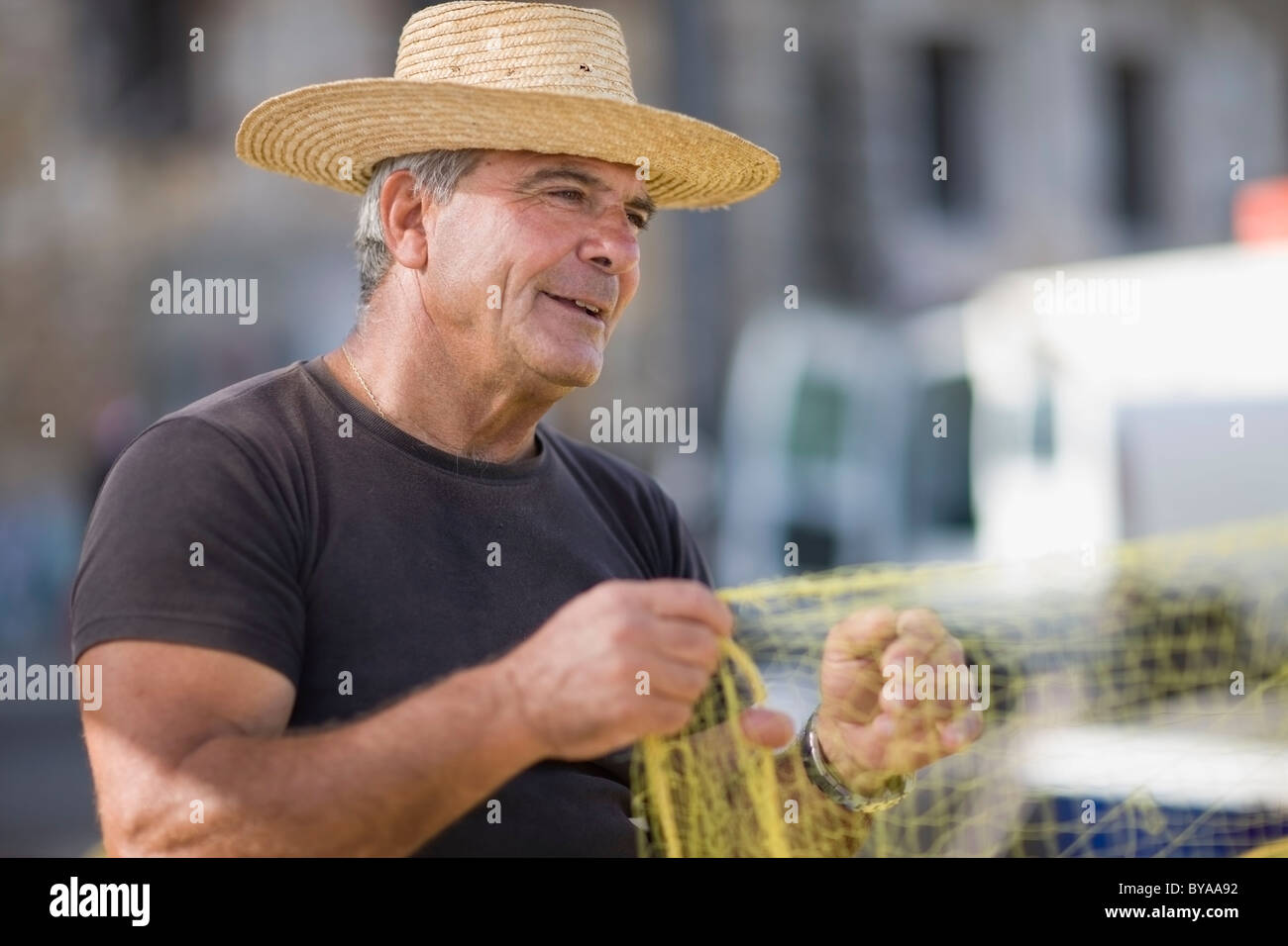 Old man preparing fishing net Stock Photo - Alamy