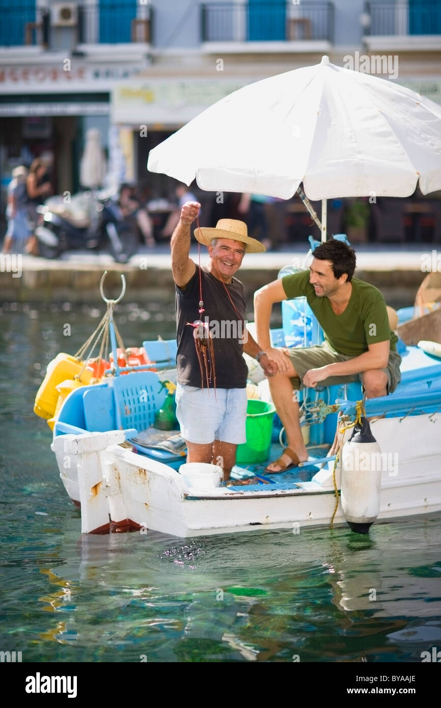 Fisher catching octopus Stock Photo - Alamy
