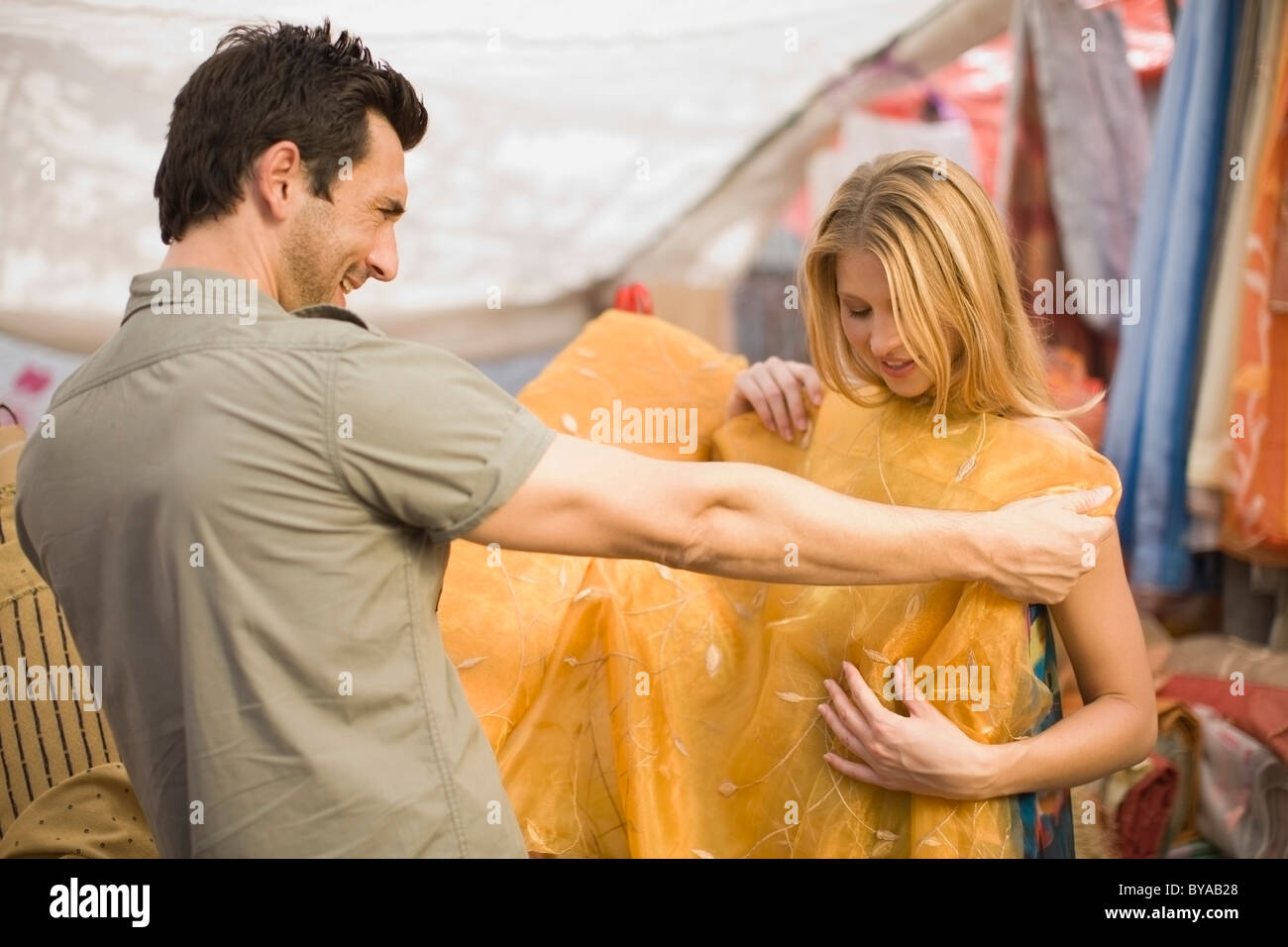 Man selling cloth Stock Photo - Alamy