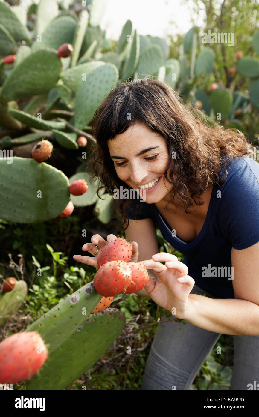 Woman touching cactus Stock Photo - Alamy
