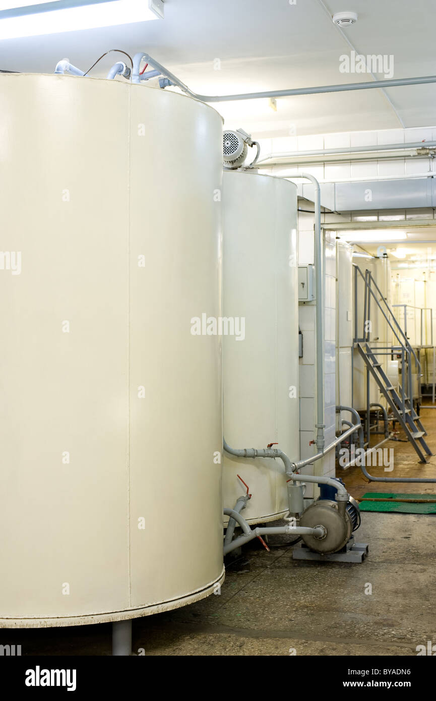 production of alcohol drinks - a line of containers with different ...