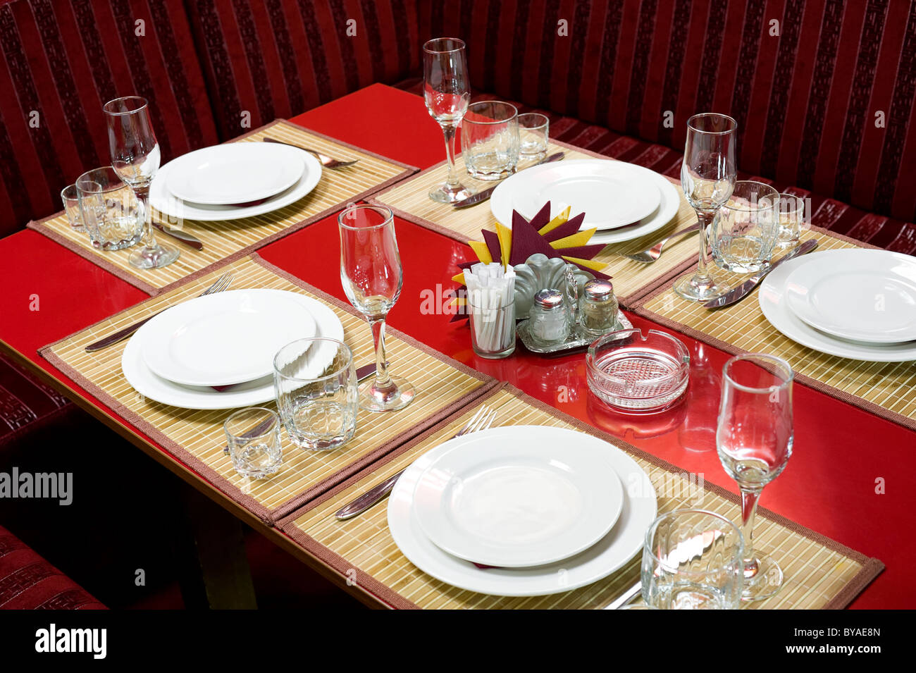 a laid red restaurant table for five persons Stock Photo - Alamy
