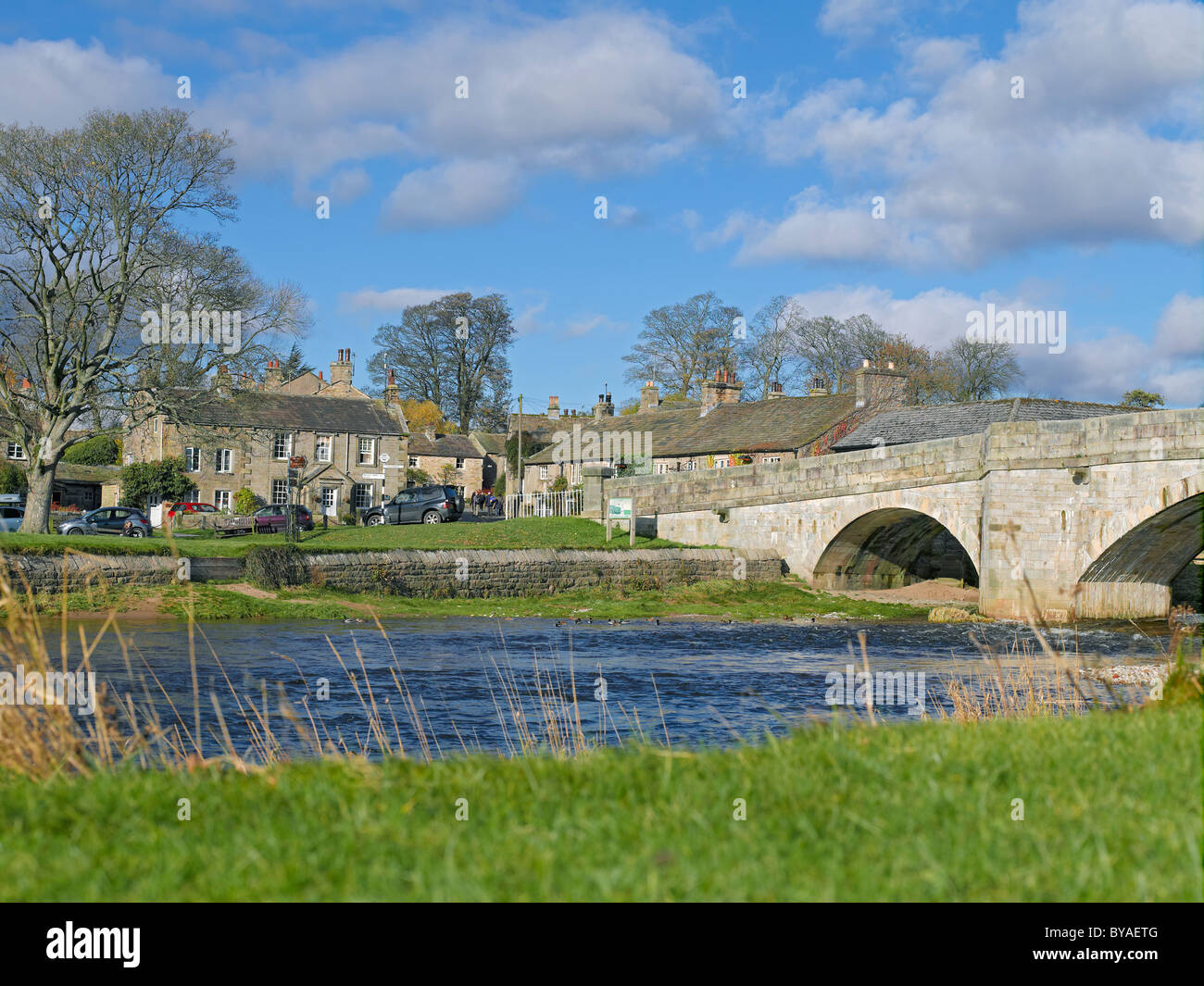 Burnsall village and bridge across River Wharfe in autumn Lower ...