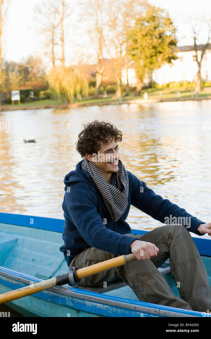 Man rowing row boat Stock Photo - Alamy