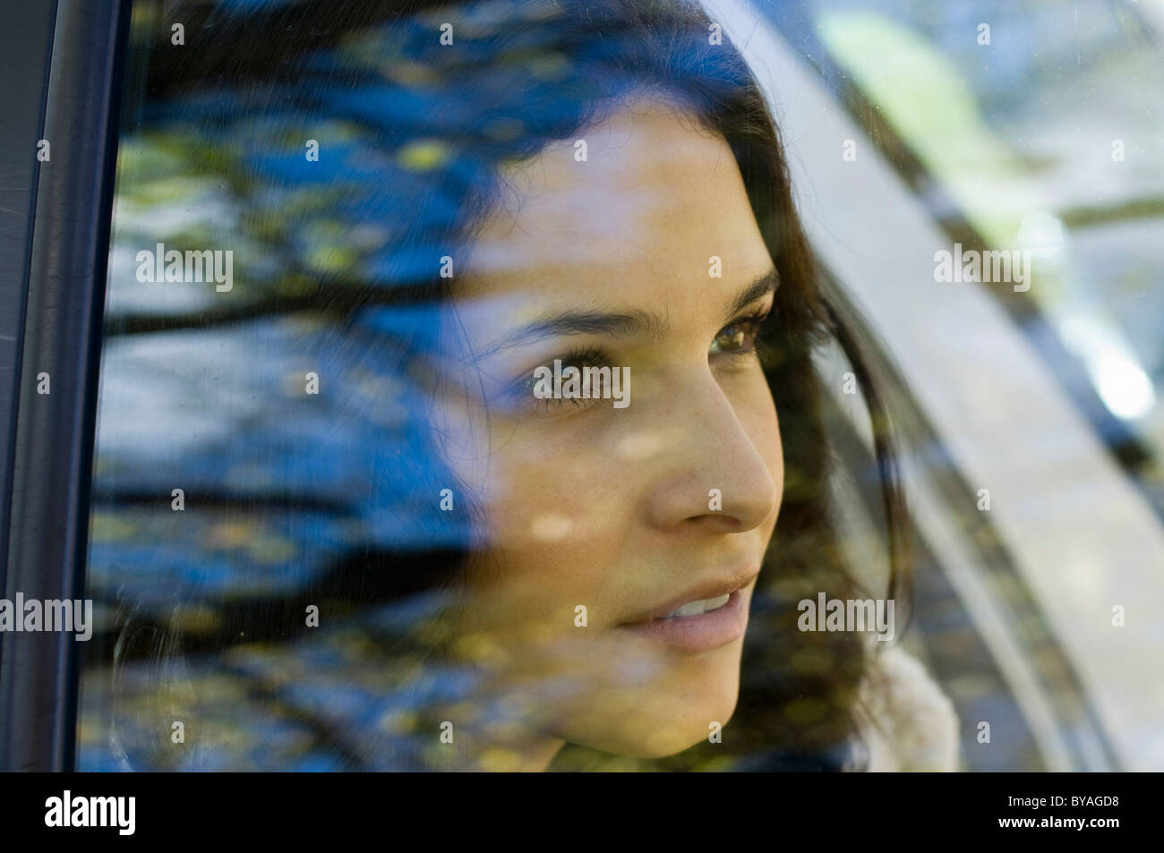 Girl in car behind windscreen Stock Photo - Alamy