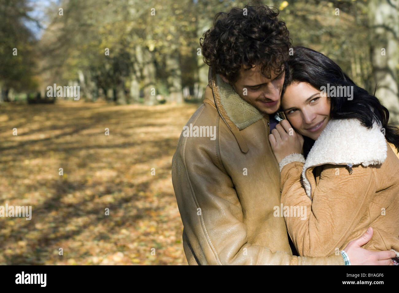 Woman snuggling against man Stock Photo - Alamy