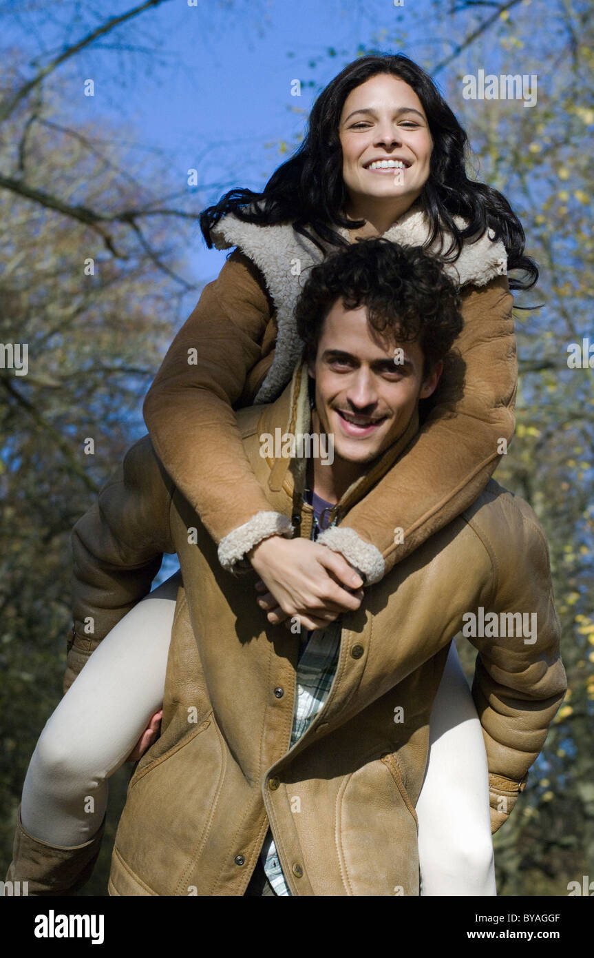 Woman on man's back Stock Photo - Alamy