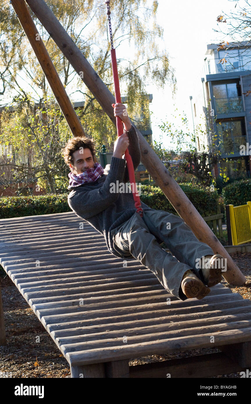 Man on swing Stock Photo - Alamy