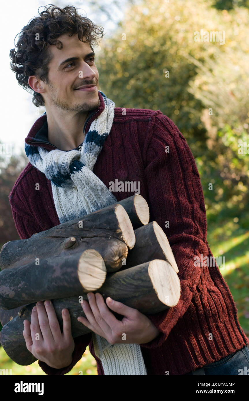 Young man carrying firewood hi-res stock photography and images - Alamy