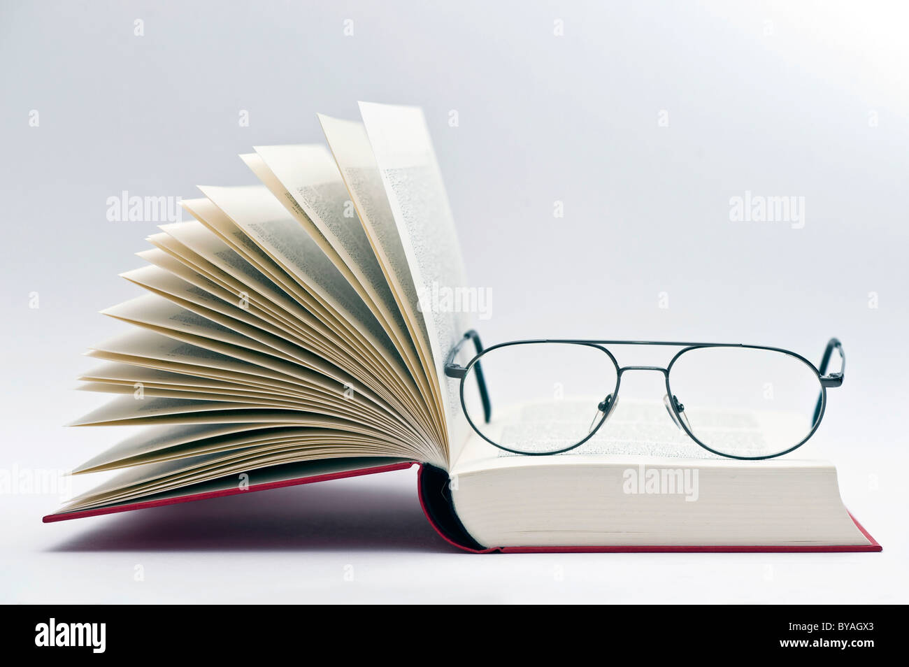 Reading glasses on an open book Stock Photo - Alamy