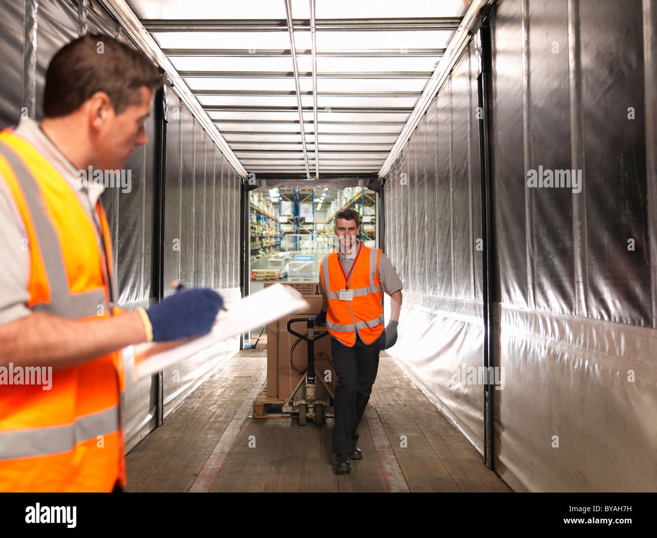 Workers loading truck Stock Photo - Alamy