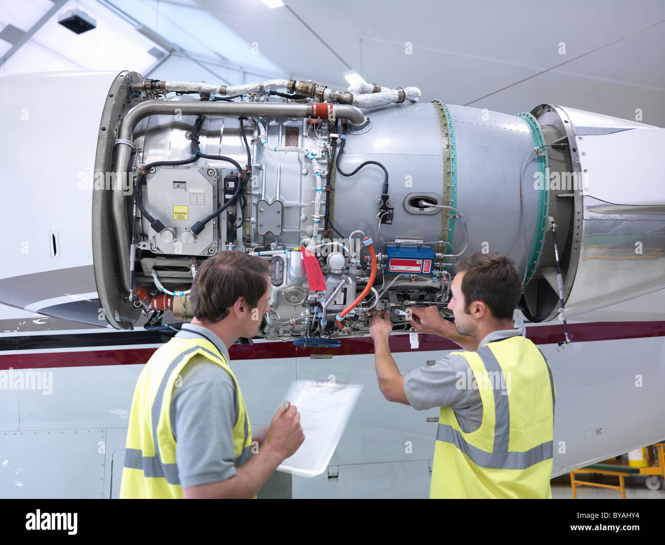 Engineers At Work On A Engine