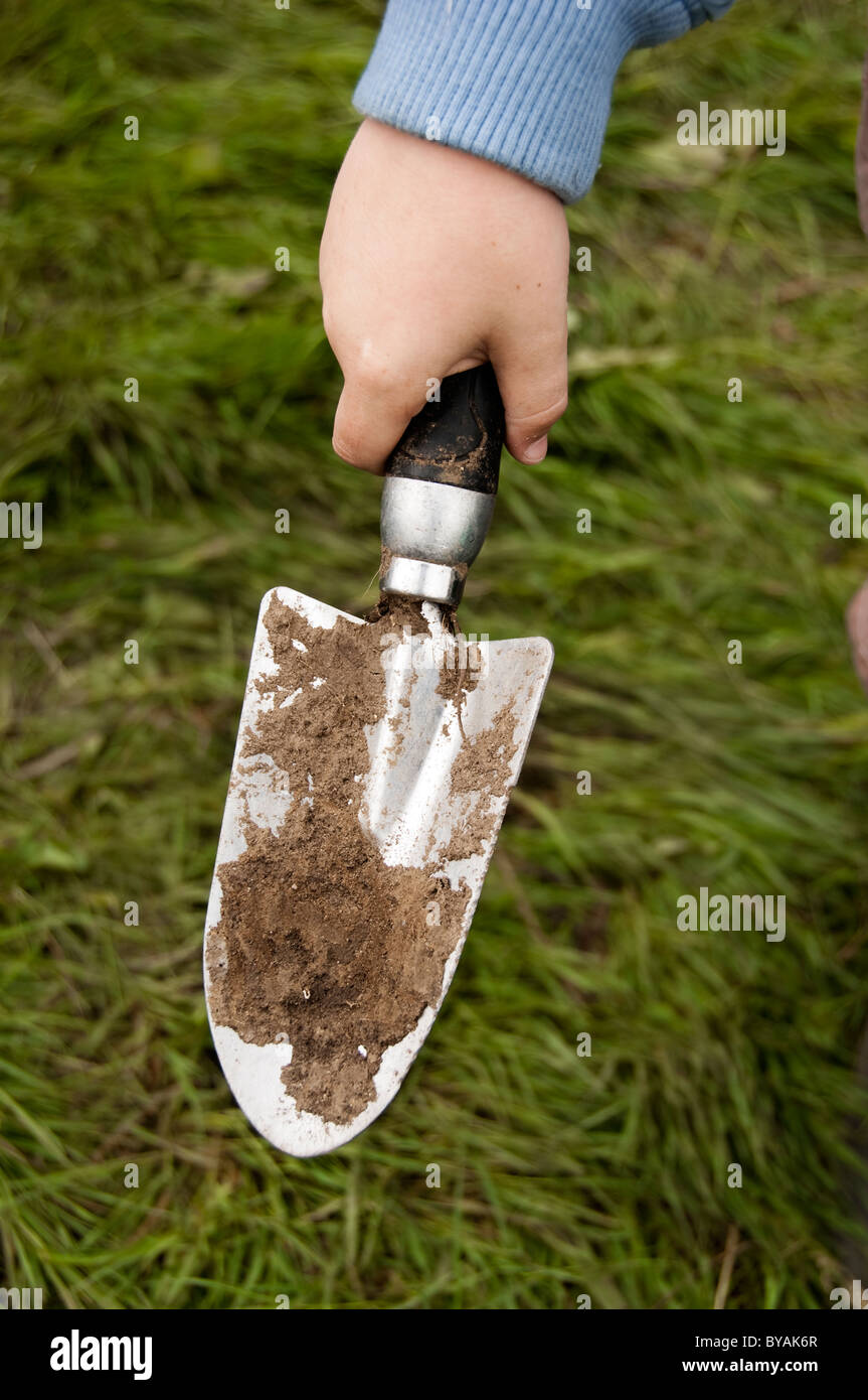 child's hand and garden trowel Stock Photo - Alamy