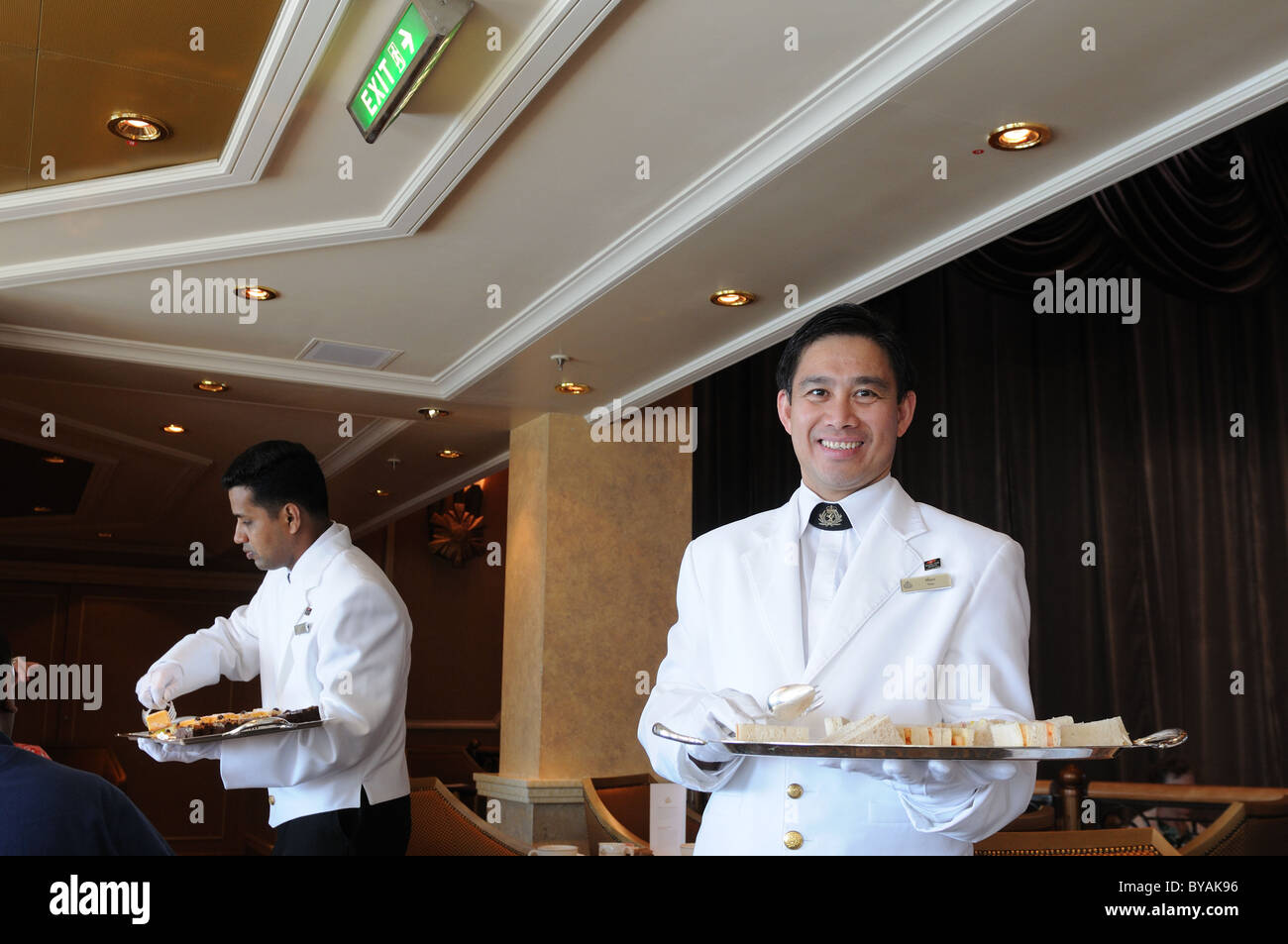 On Cunard's ship, "Queen Elizabeth," waiters serve afternoon tea with a ...