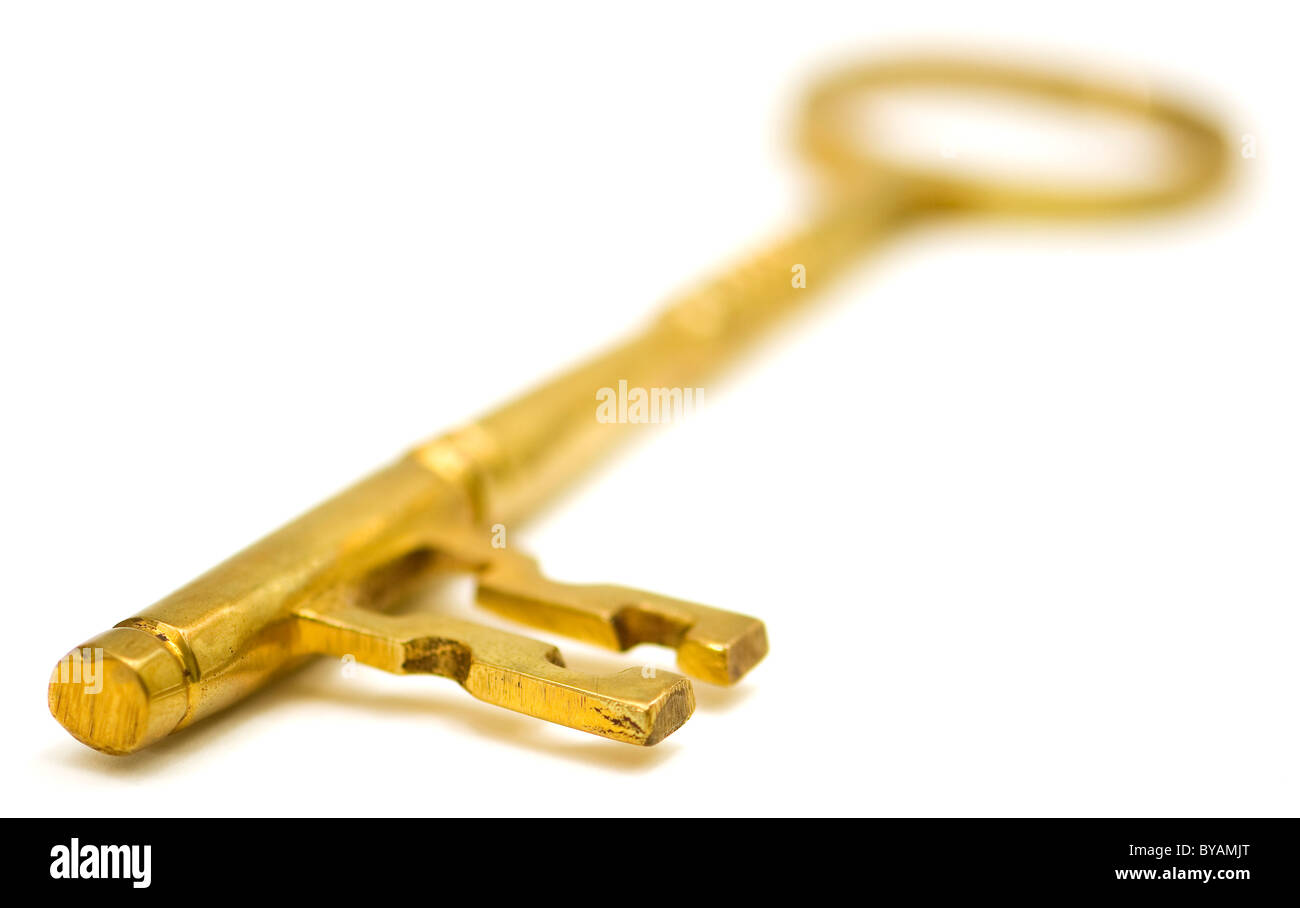 Gold, antique skeleton key on side with very narrow depth of field ...
