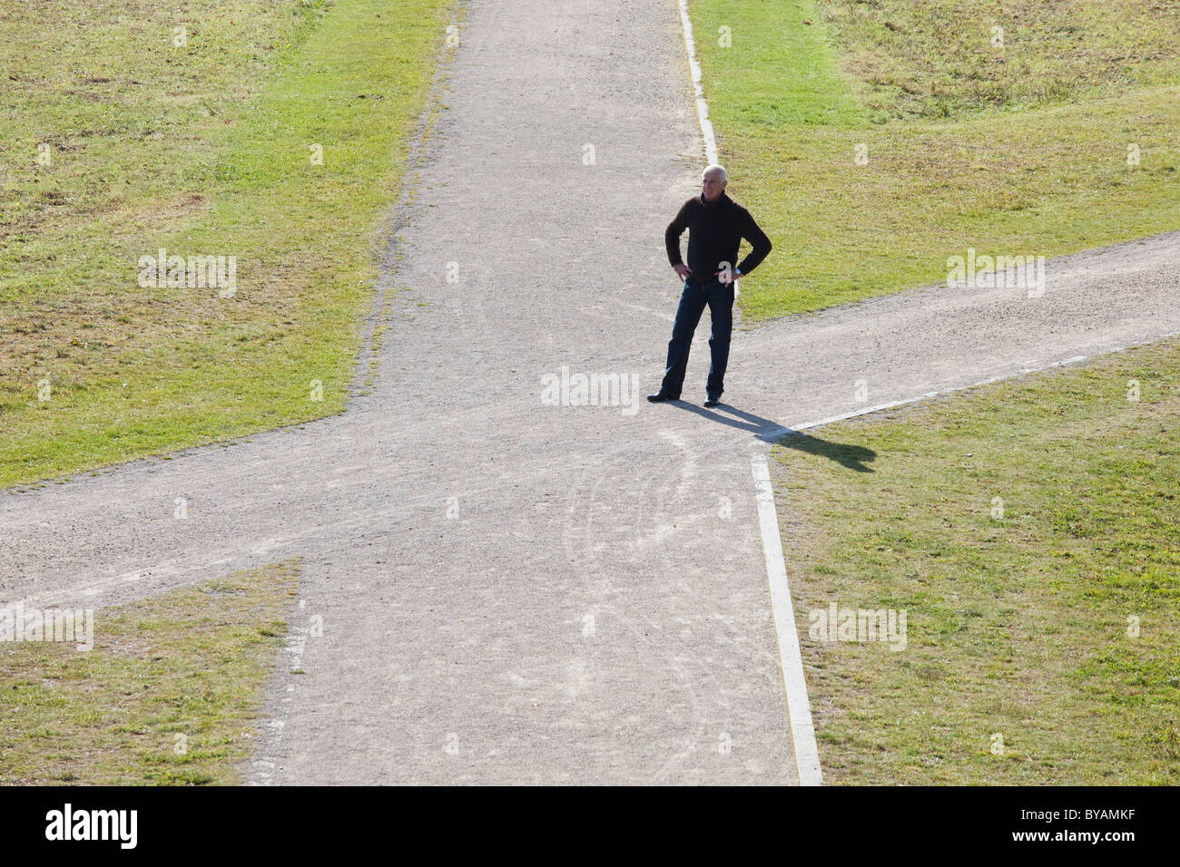 Man standing at a crossroads Stock Photo - Alamy