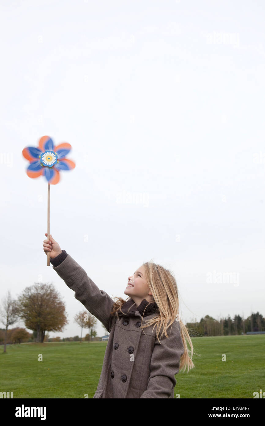 Girl holding wind wheel Stock Photo - Alamy
