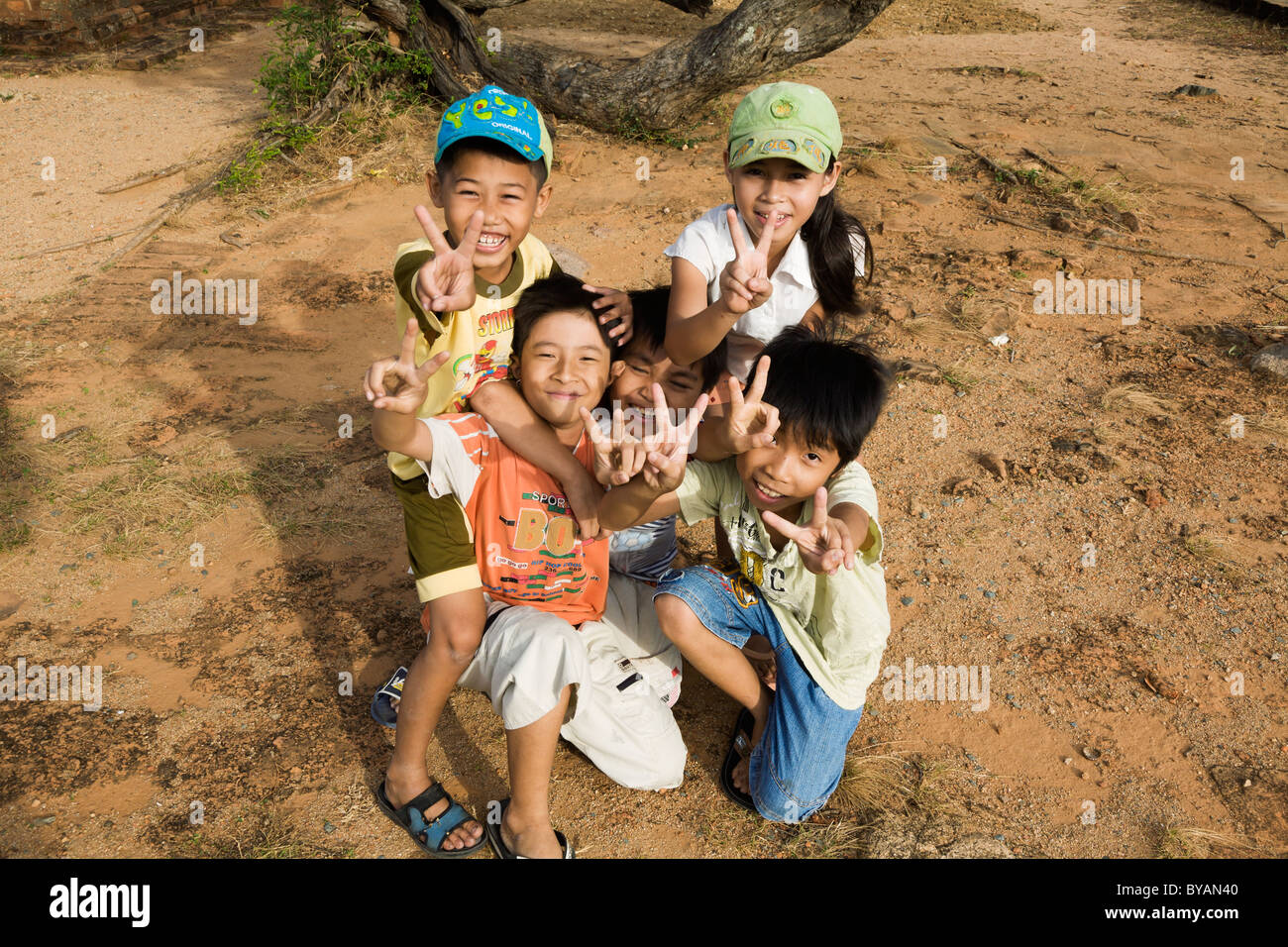 Group of happy children making peace signs by Po Klong Garai Cham ...