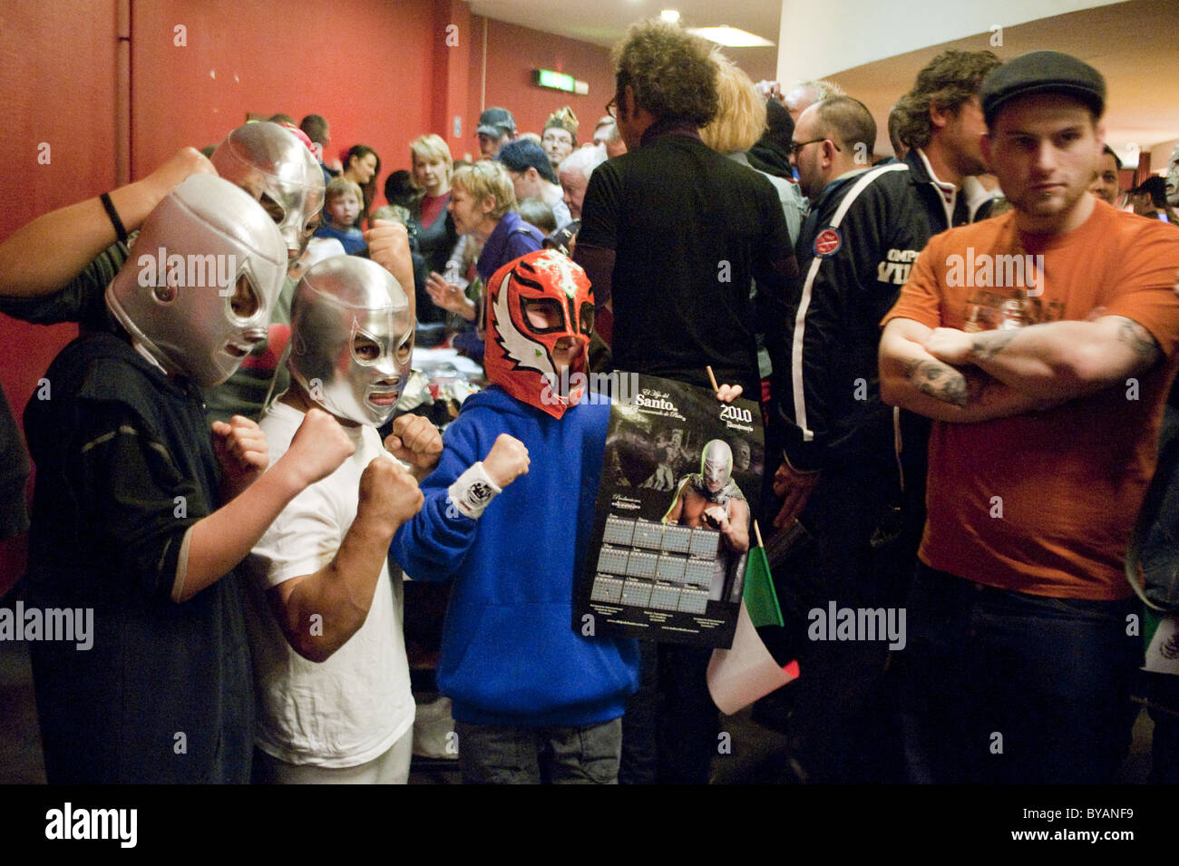 Kids posing with a dwarf luchador (center) for a photo wearing masks of ...