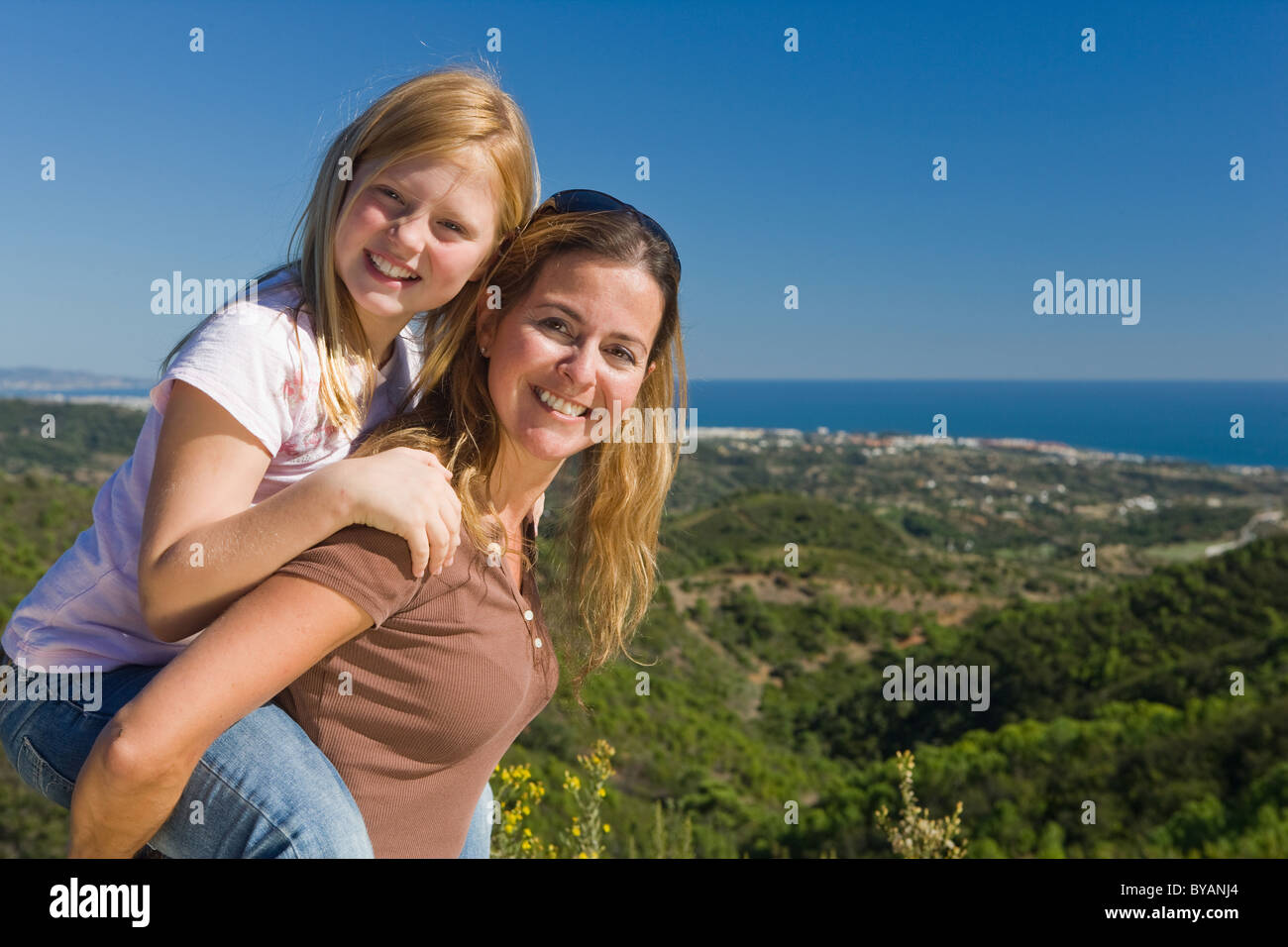 Mother and daughter piggyback ride Stock Photo - Alamy