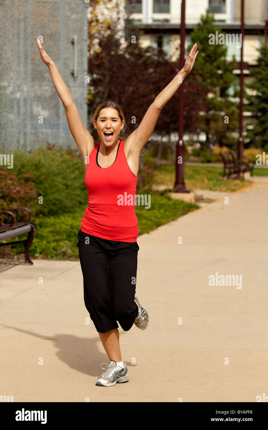 Outdoor spring training exercise in city park showing beautiful young ...