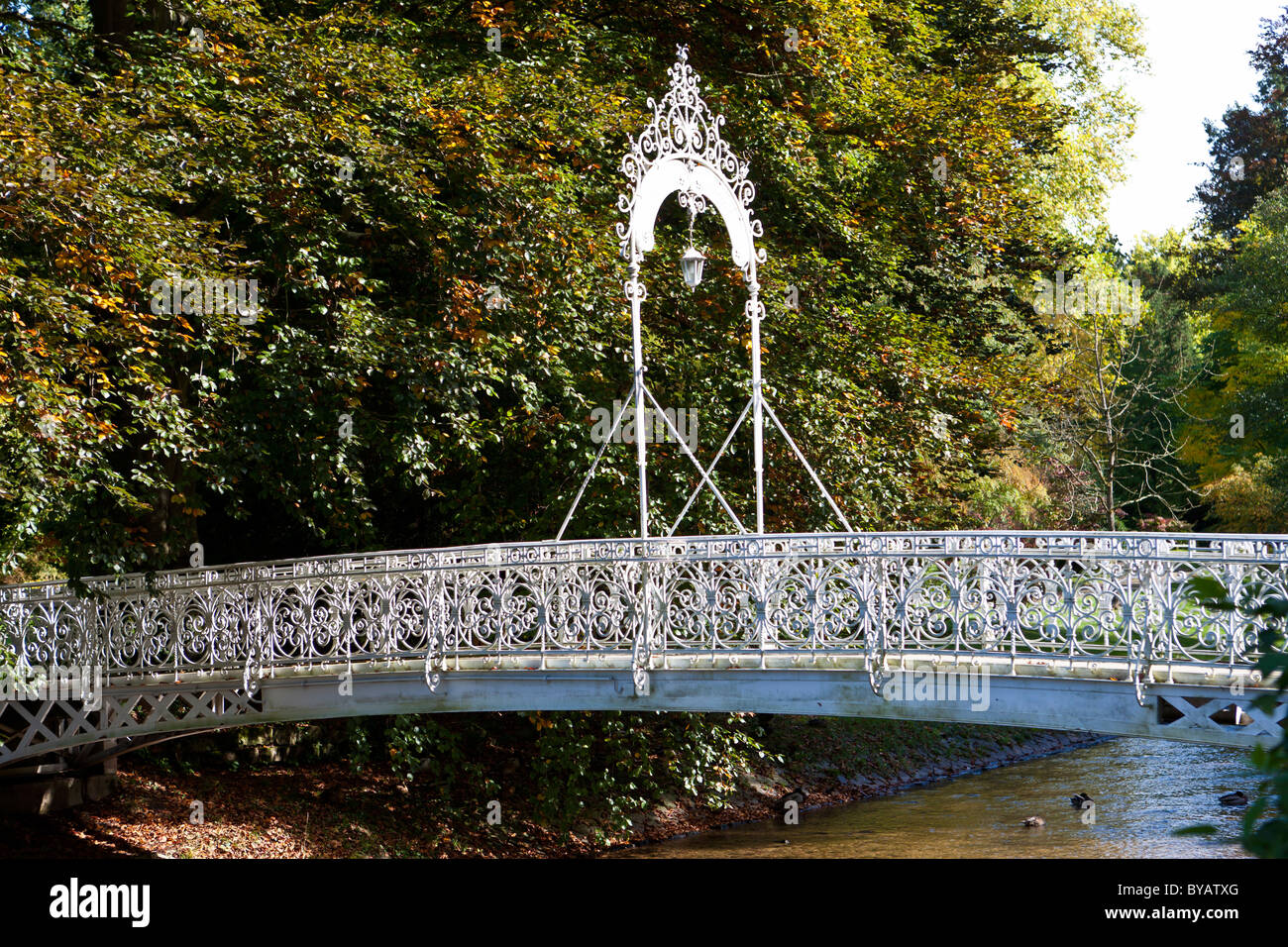 Ornate bridge over the river Oos to the Hotel Bellevue with park on the ...