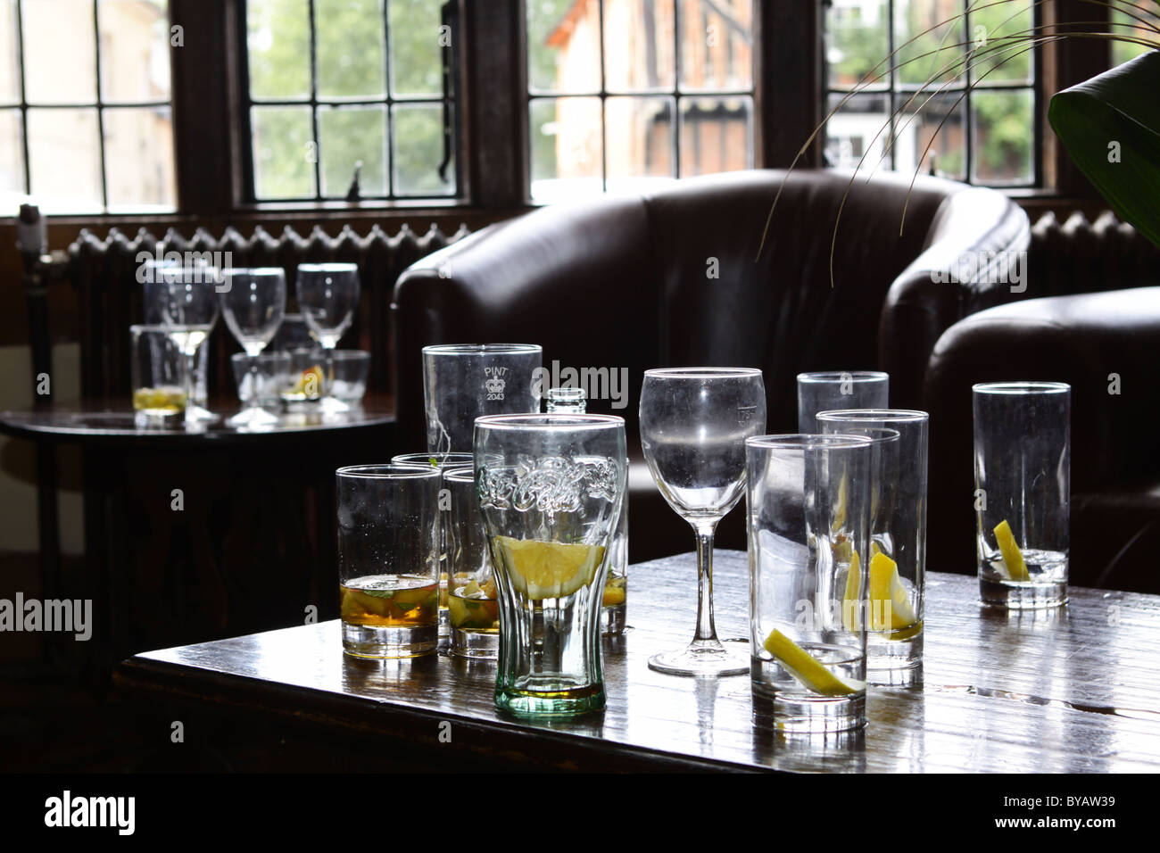 empty glasses left in a lounge or bar area after the party has finished ...