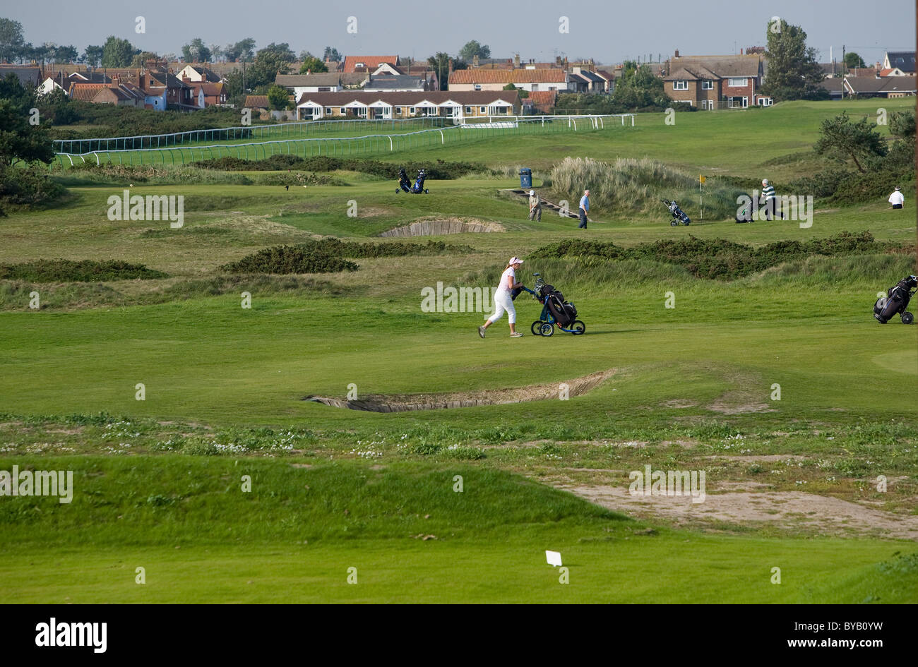 Golfers walking with caddies hi-res stock photography and images - Alamy