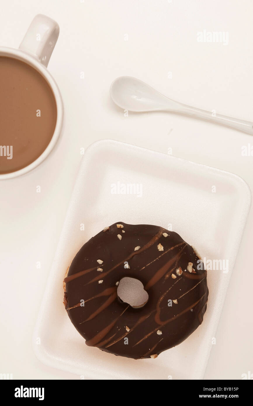 Coffee break with a chocolate donut Stock Photo - Alamy