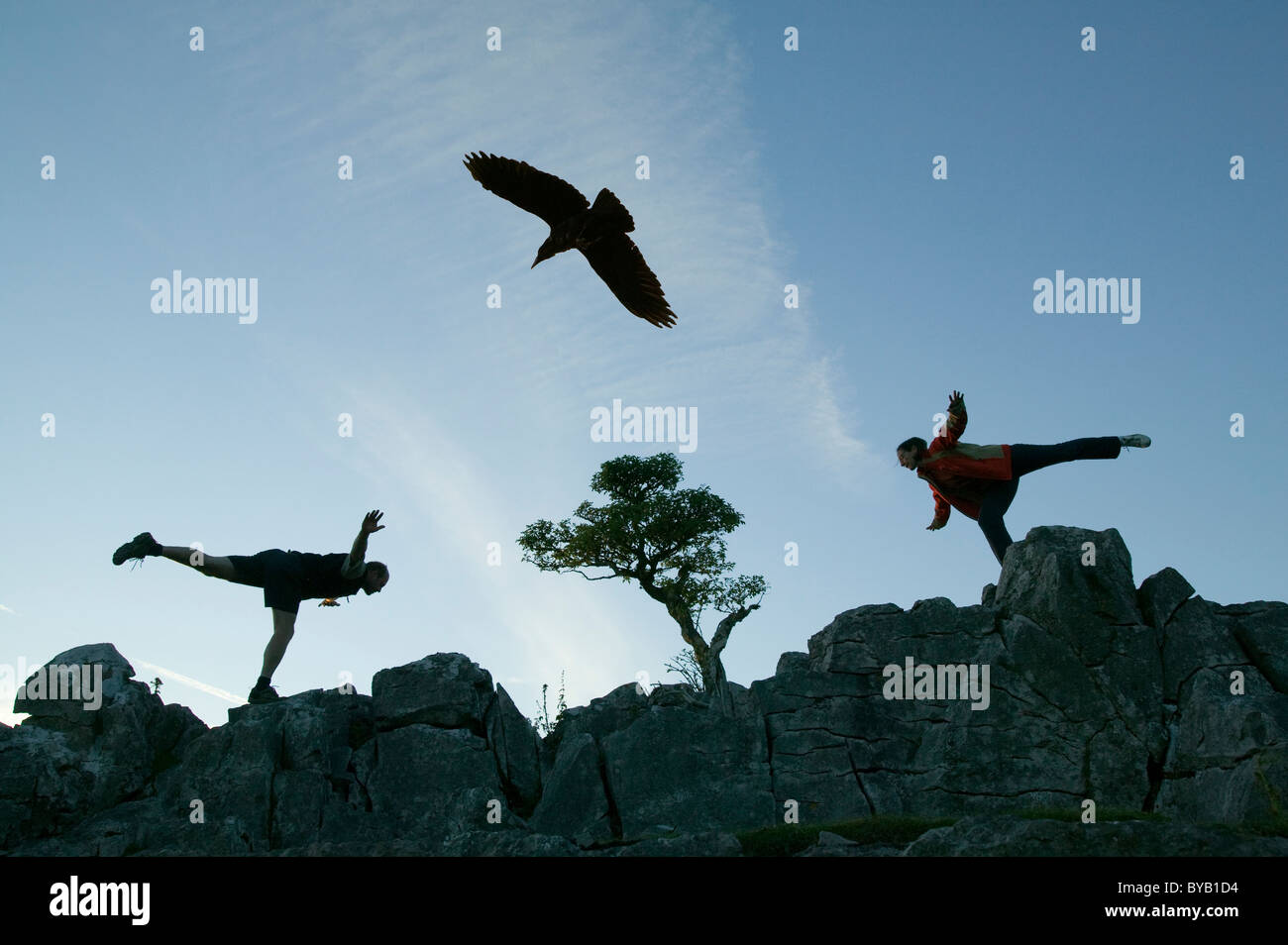 a man and women performs aerobic tai chi type exercise on limestone ...