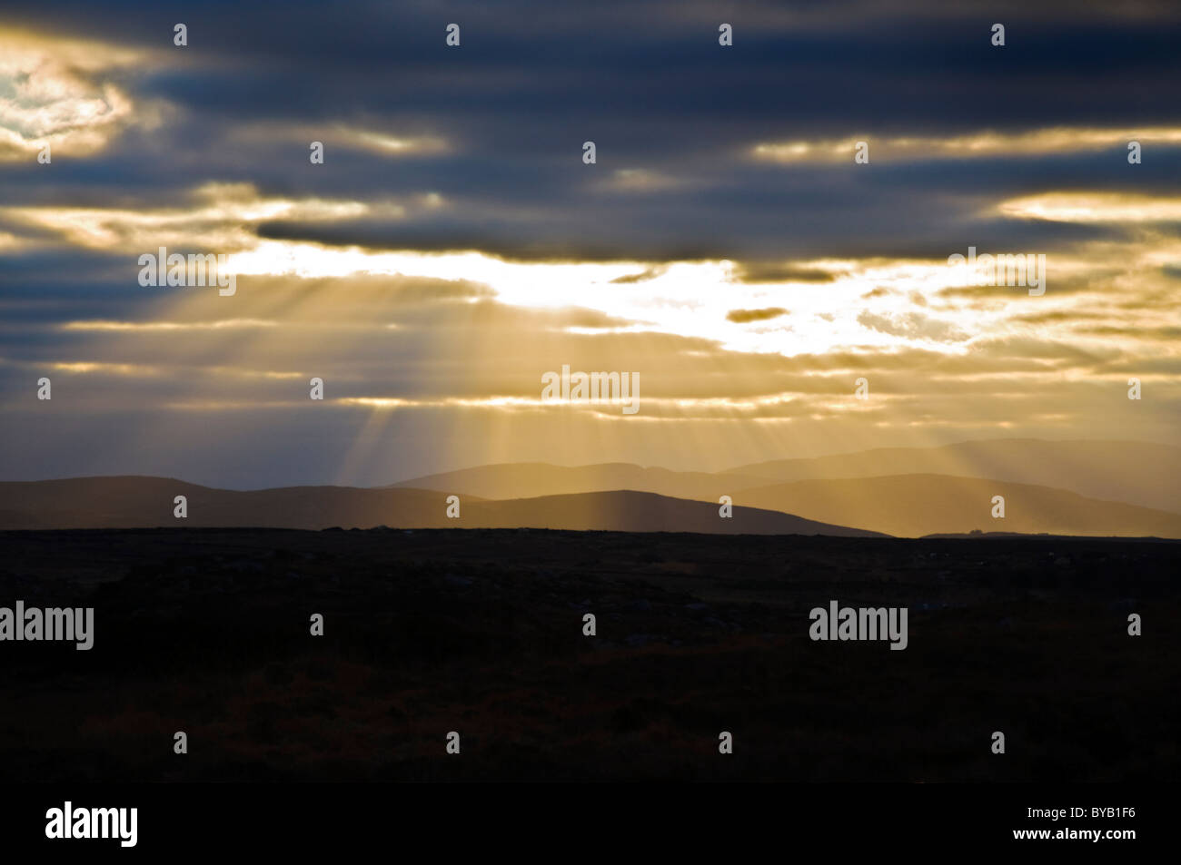 Sunlight burst through stormclouds over the rugged Donegal landscape ...