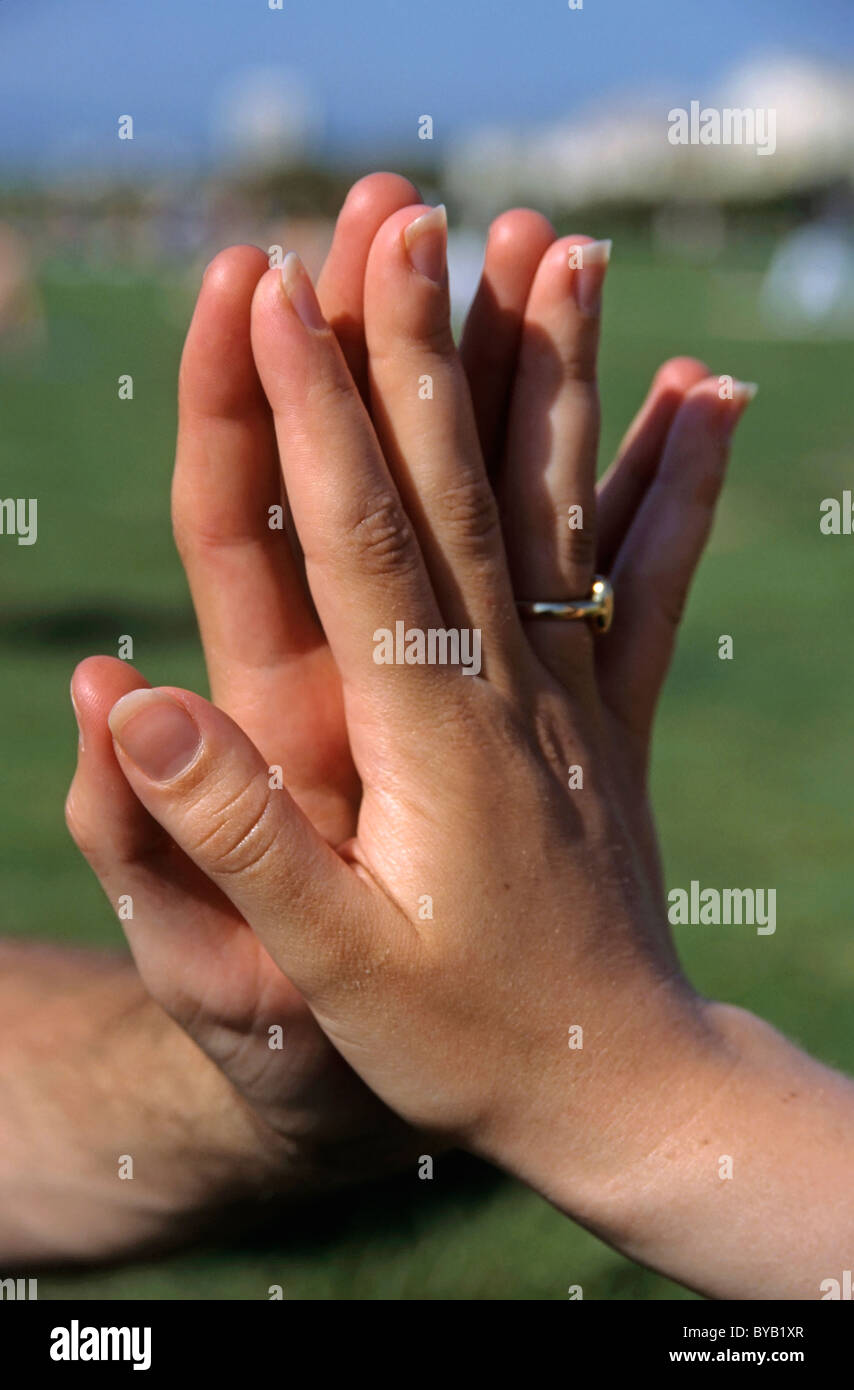 Man and woman pressing their hands together Stock Photo - Alamy