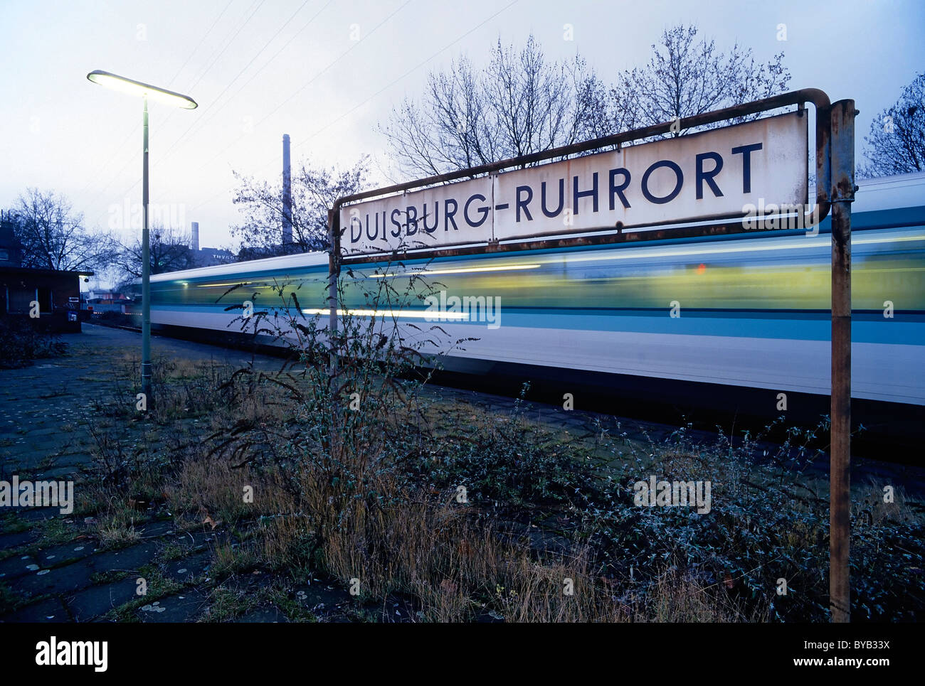 Overgrown platform, train passing, Duisburg-Ruhrort suburban train ...