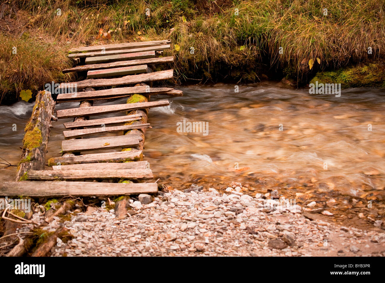 Small wooden bridge over a brook Stock Photo - Alamy