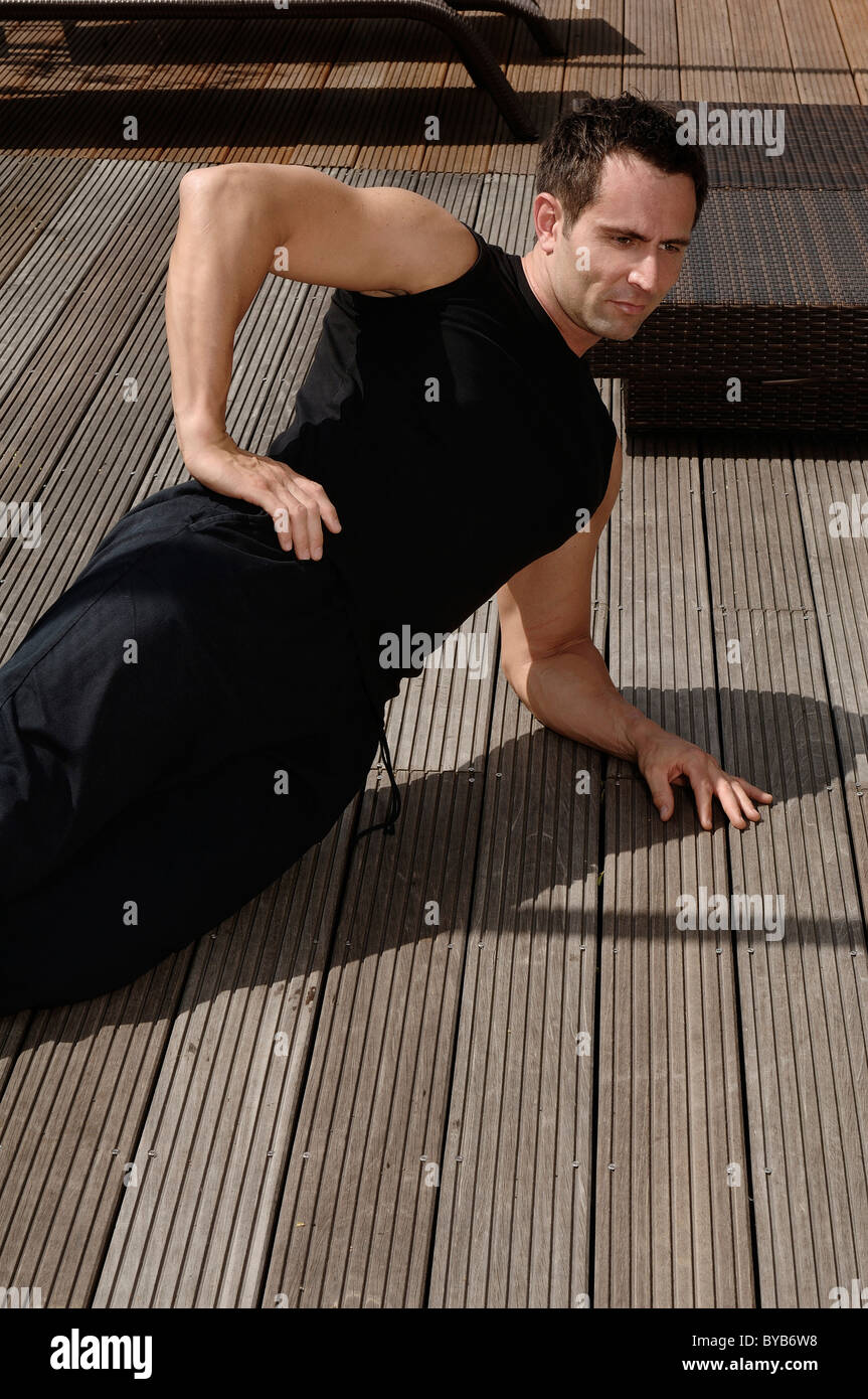 Athletic man doing power exercises on a terrace Stock Photo - Alamy