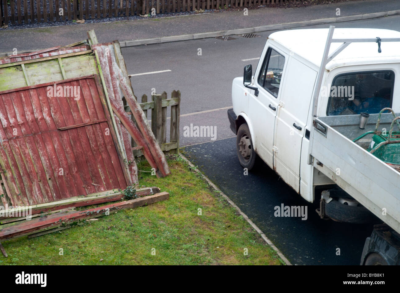 Builders Pick Up Van with Broken Garden Fencing Stock Photo - Alamy