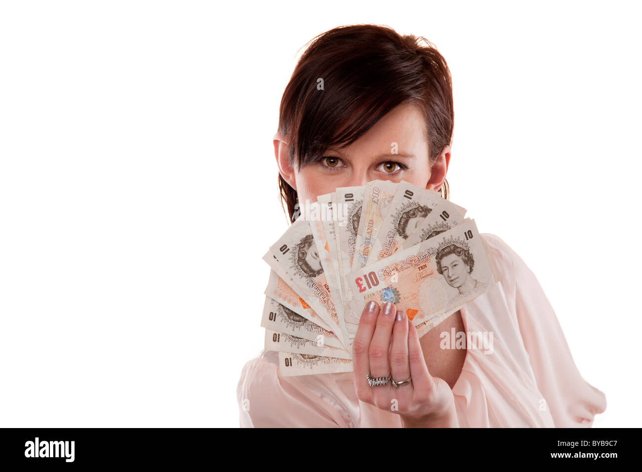 Brunette woman holding ten pound notes in her hands Stock Photo - Alamy