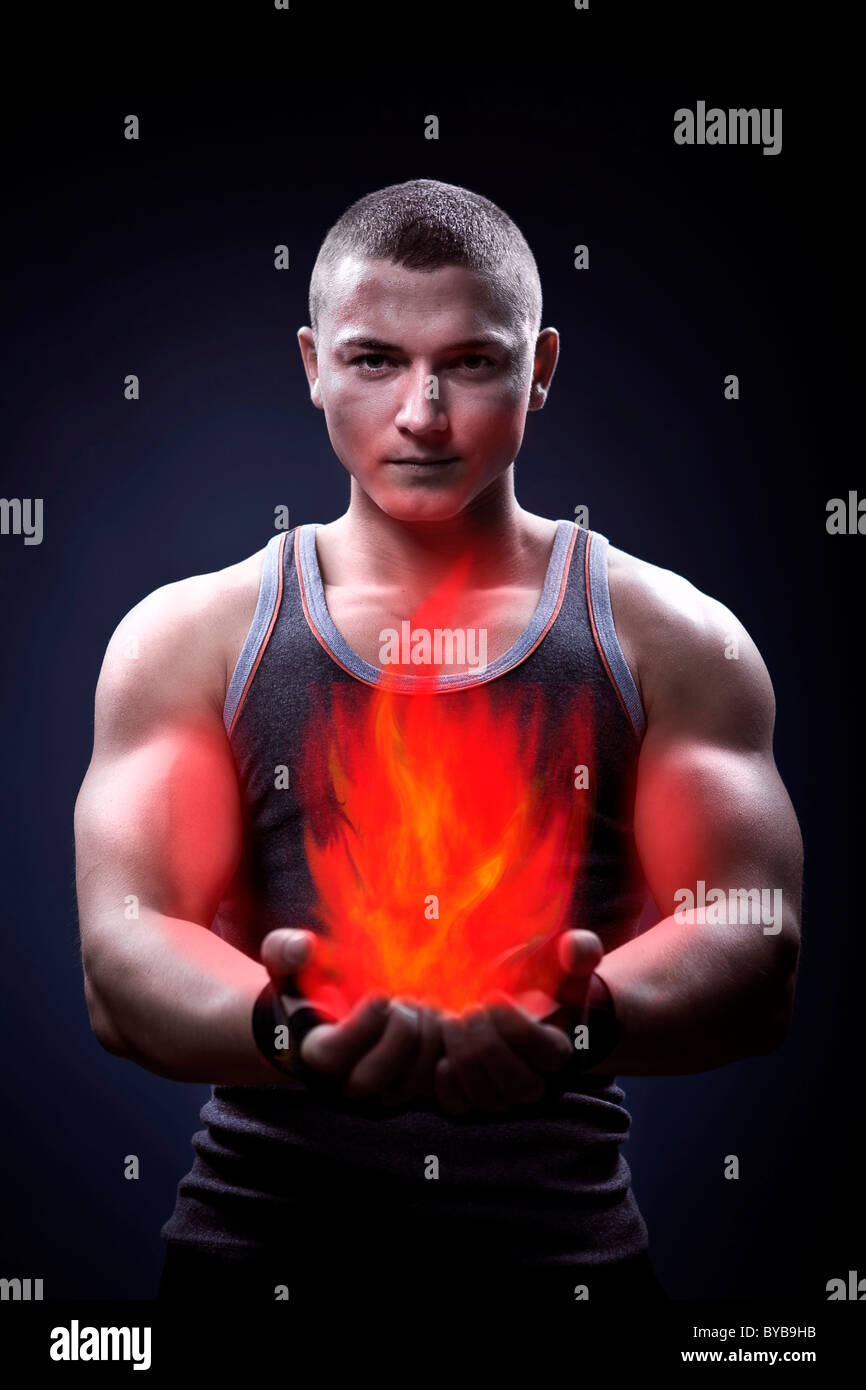 Young athlete with fire in his hands Stock Photo - Alamy