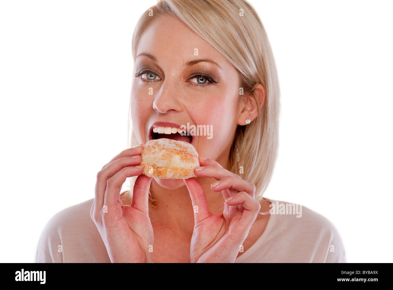 blonde woman eating a doughnut Stock Photo - Alamy