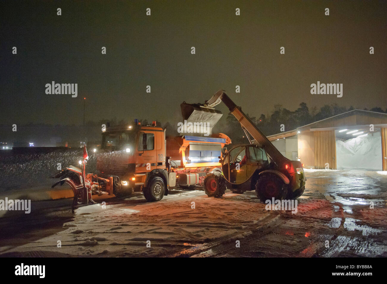 Winter services vehicles are loaded with road salt at the salt storage ...